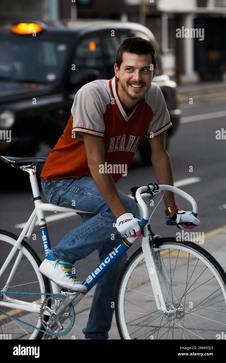 Male on a bicycle in traffic with taxi in background London, UK Stock ...