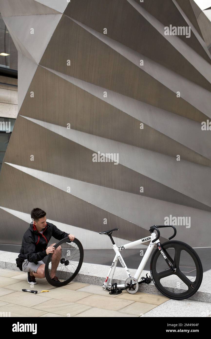 A bicycle wheel puncture, a man repairs a bicycle Stock Photo - Alamy