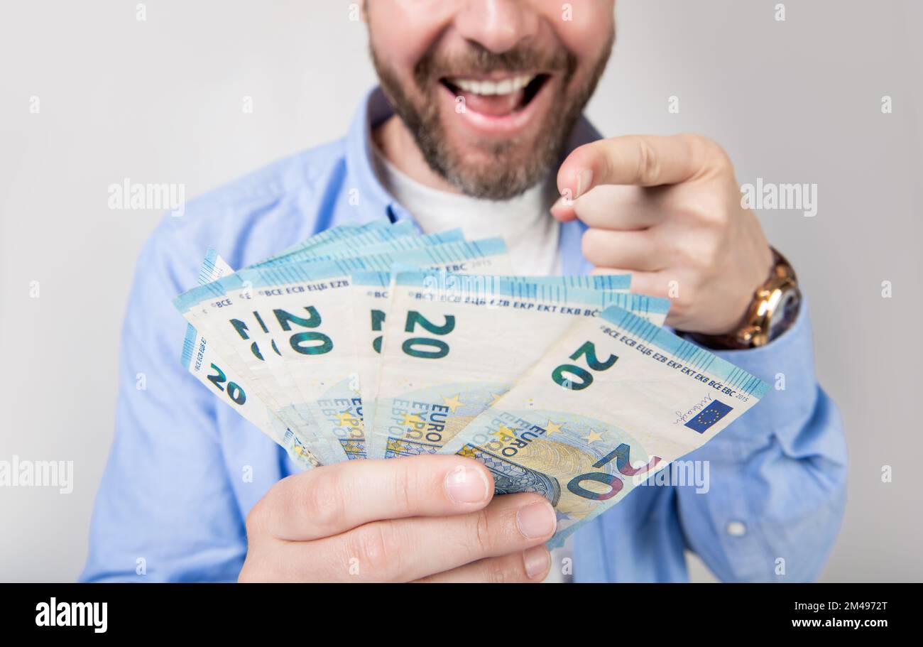 man with cash money pointing finger in studio. man with cash money ...
