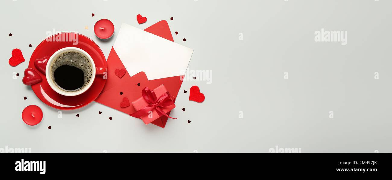 Blank letter, gift, candles and cup of coffee on light background with ...