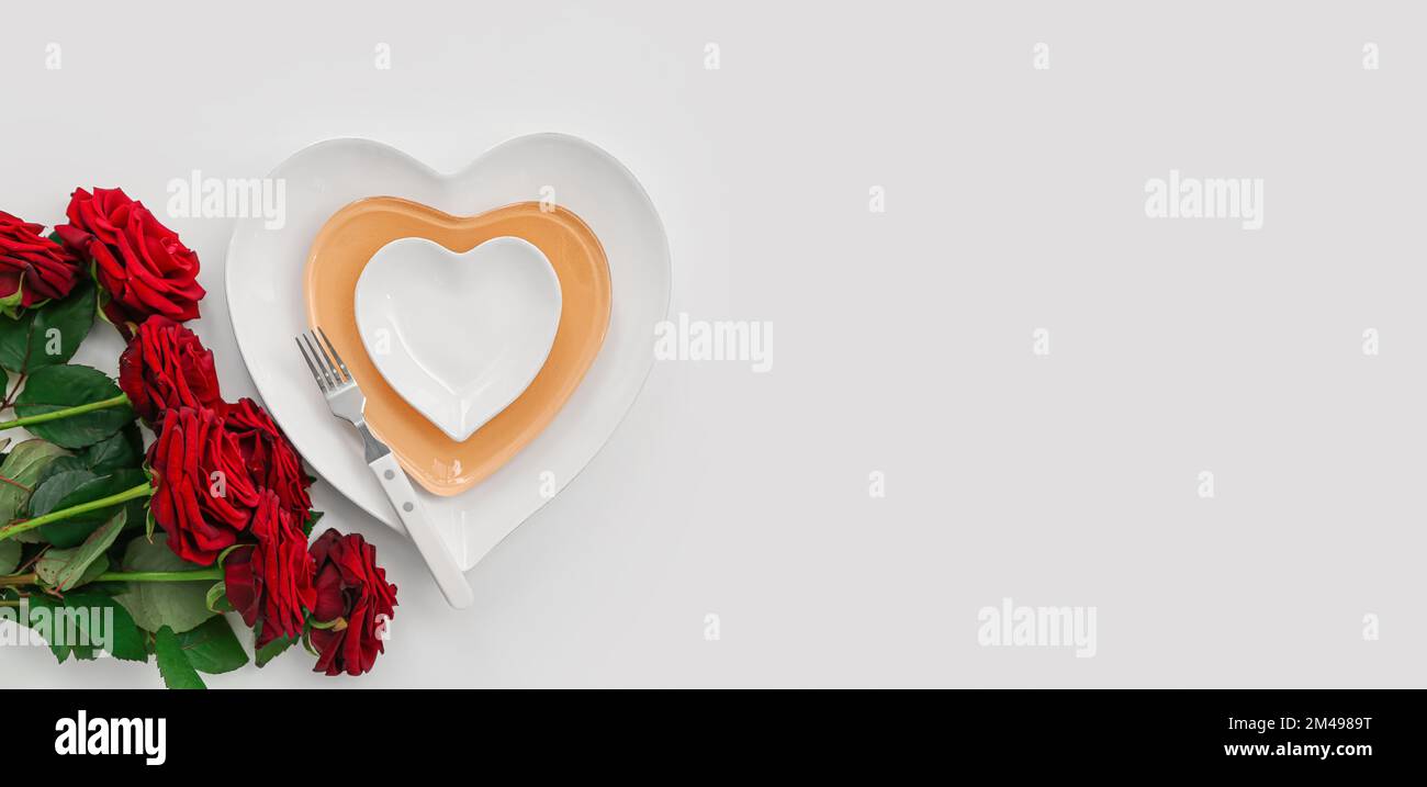 Beautiful table setting for Valentine's Day with red roses on white ...