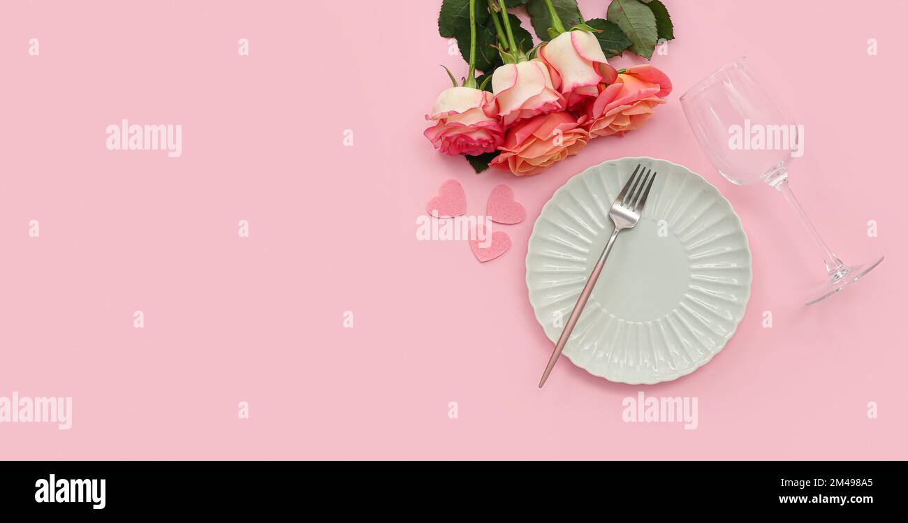 Table setting for Valentine's Day with hearts and rose flowers on pink ...