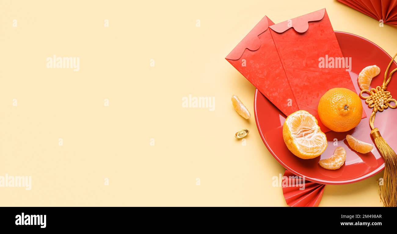 Red envelopes and Chinese symbols on light yellow background with space ...