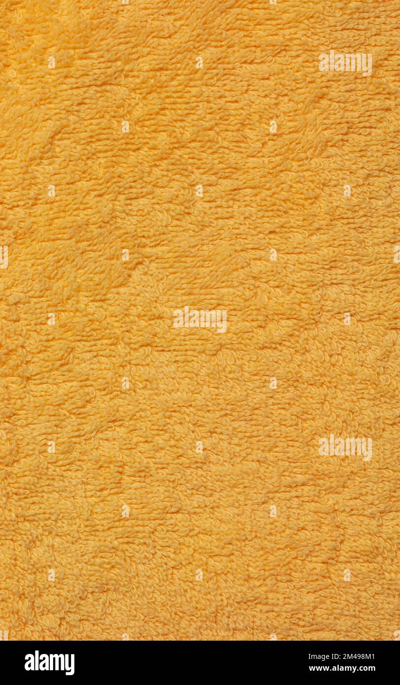 Yellow terry cloth for towels. Yellow fabric and texture concept. Close ...