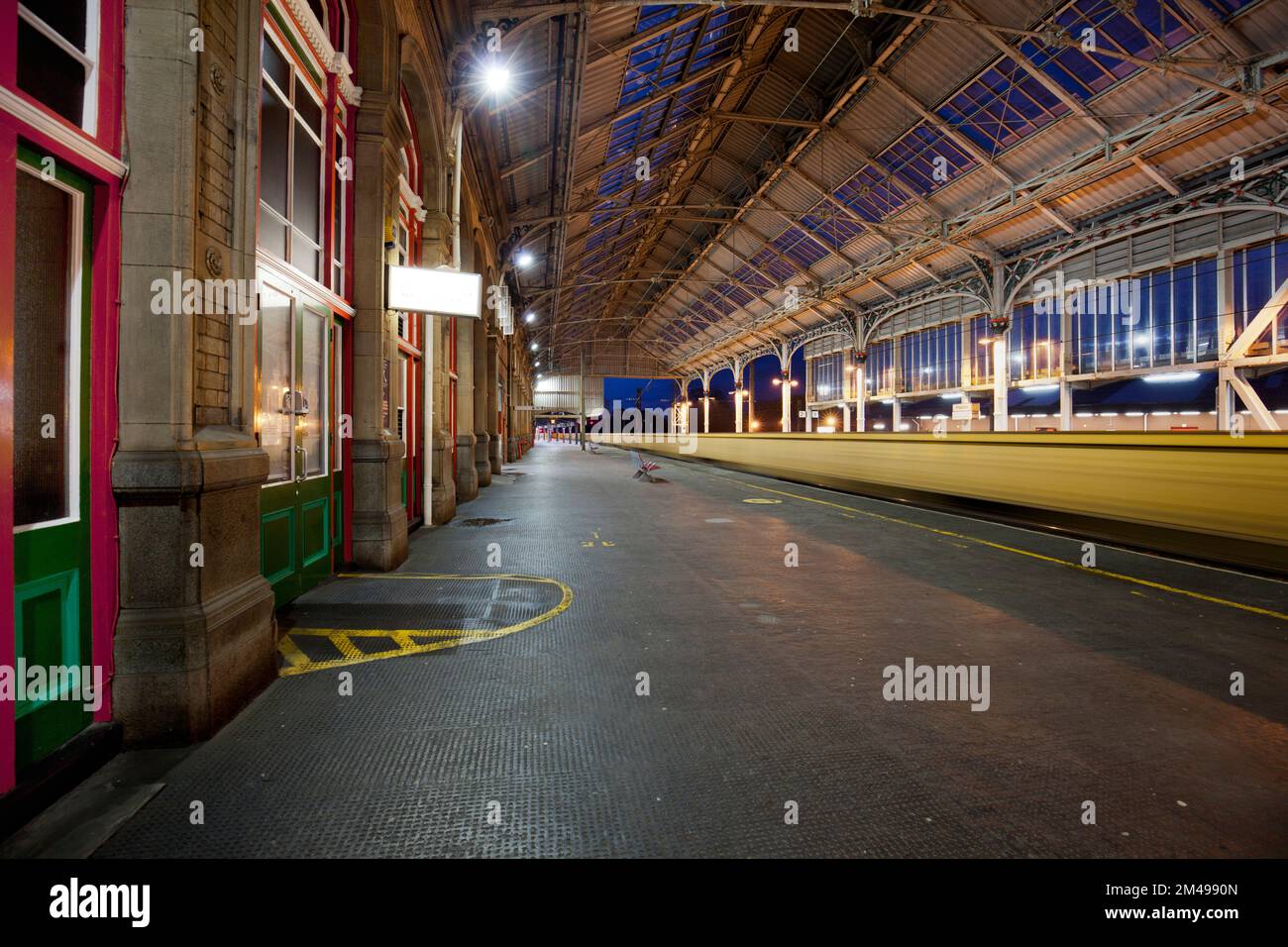 Freight train passing through Preston railway station, with motion blur ...