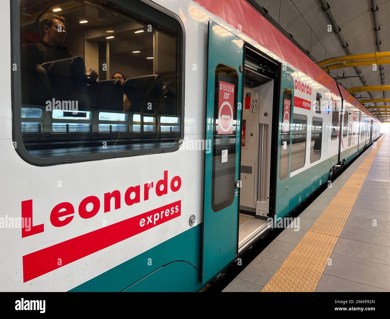 Passengers board the Trenitalia Leonardo Express train at Fiumicino ...