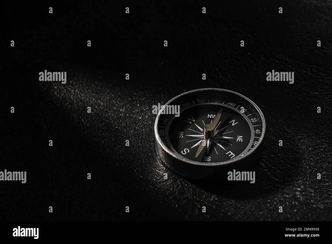 Black compass on dark background Stock Photo - Alamy