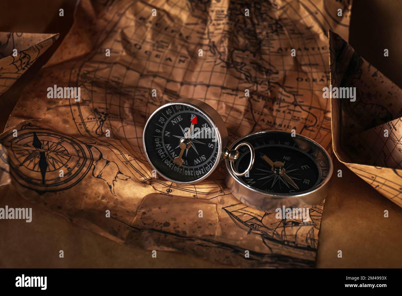 Small compasses on world map Stock Photo - Alamy