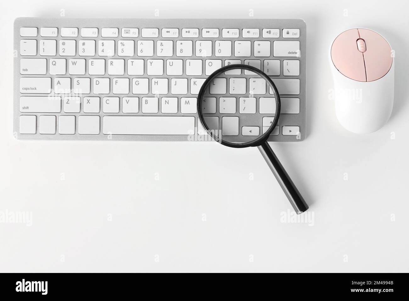 Keyboard, computer mouse and magnifier on white table. Internet search ...