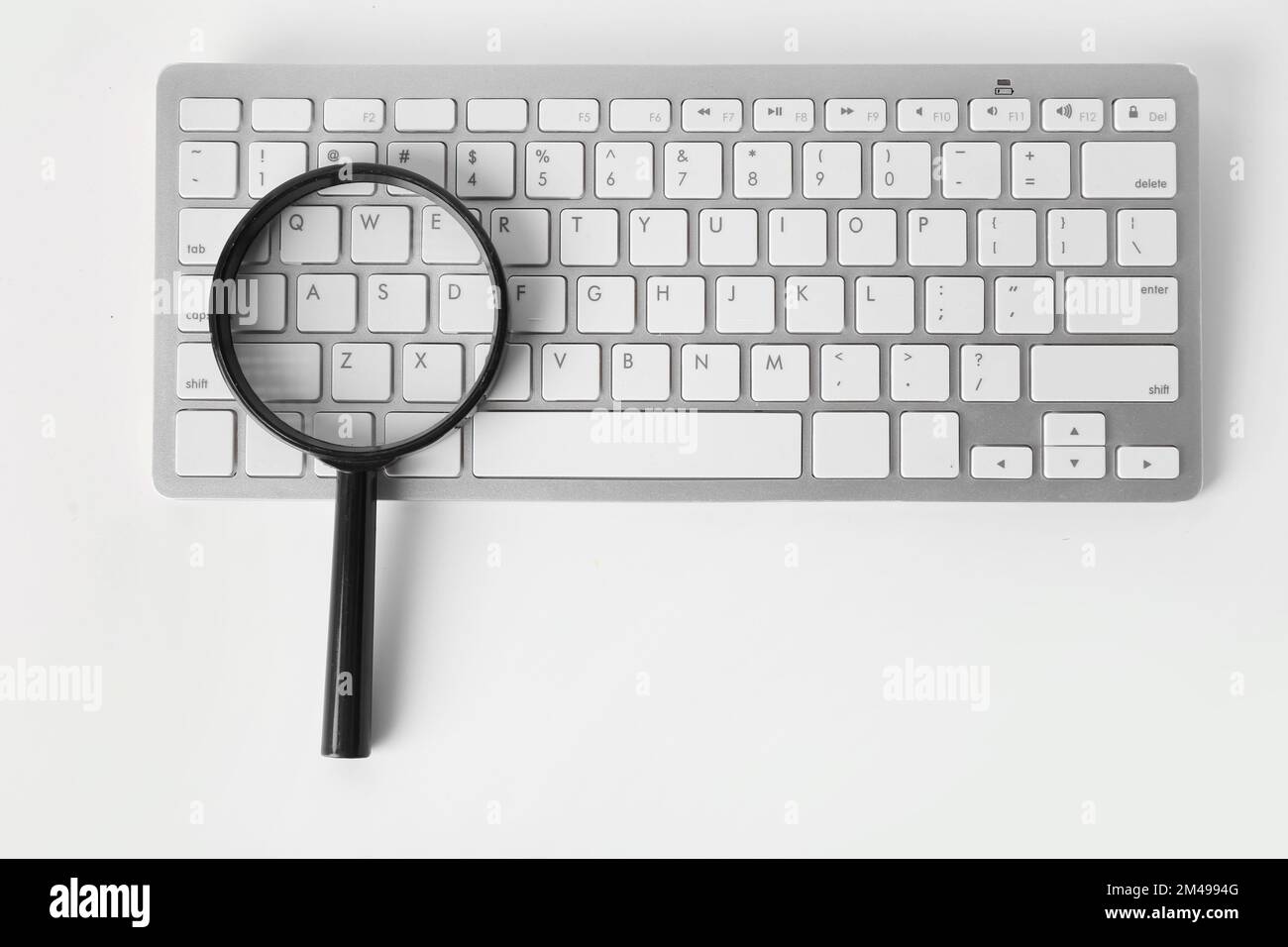 Keyboard and magnifier on white table. Internet search concept Stock ...