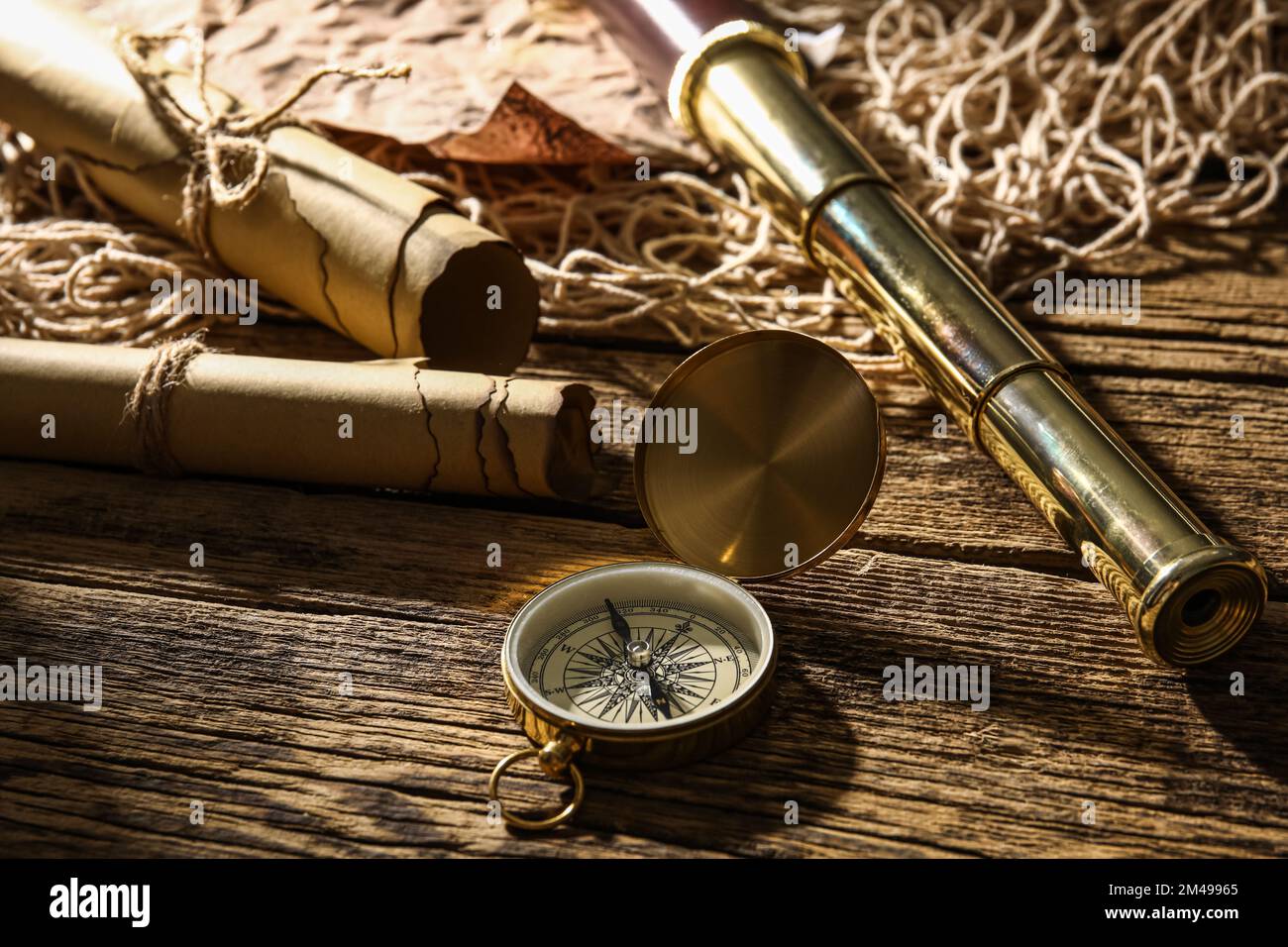Compass with spyglass and maps on dark wooden background Stock Photo ...