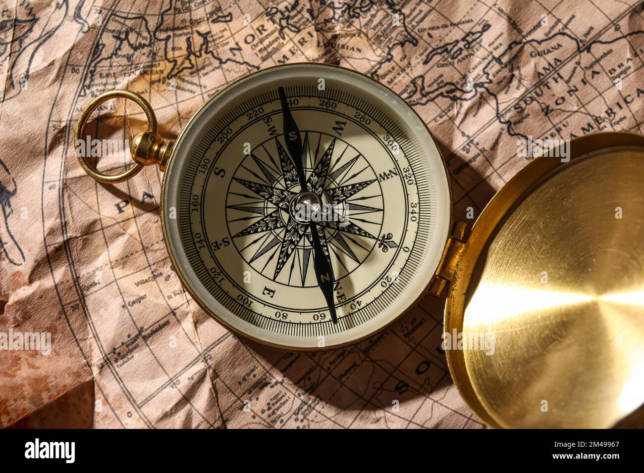 Golden compass on world map, top view Stock Photo - Alamy