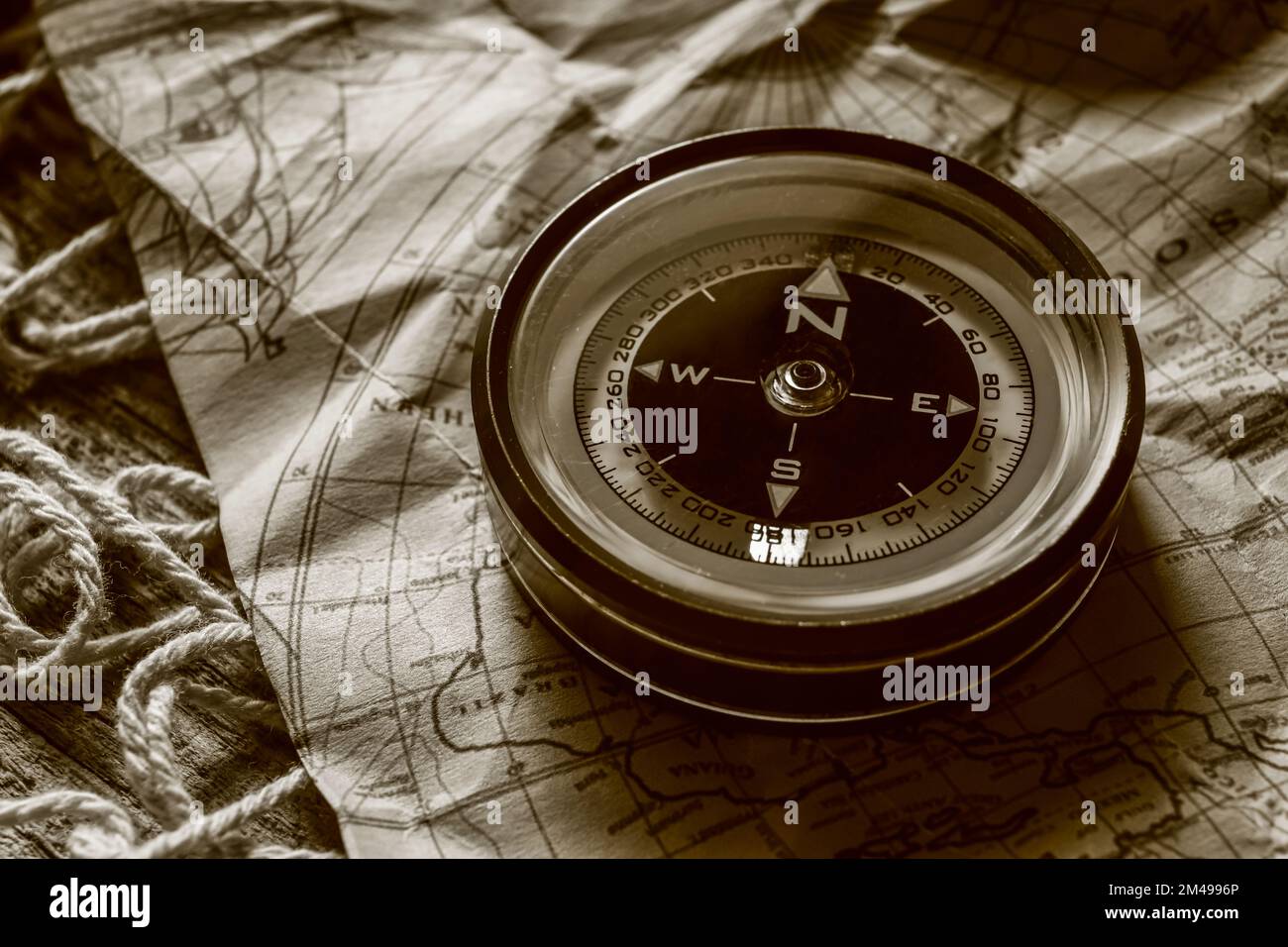 Compass on world map, closeup Stock Photo - Alamy