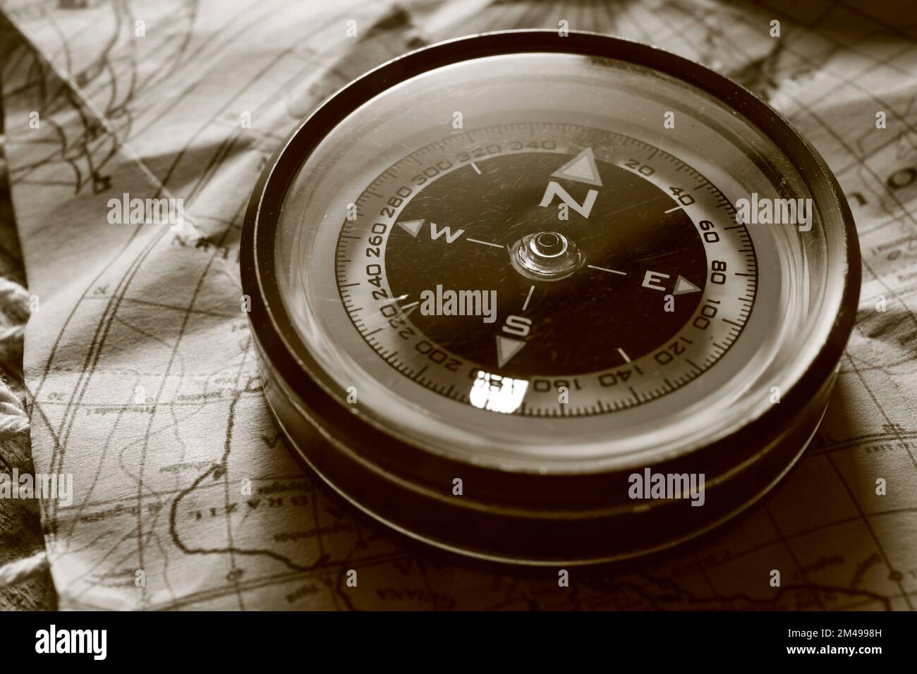 Compass on world map, closeup Stock Photo - Alamy