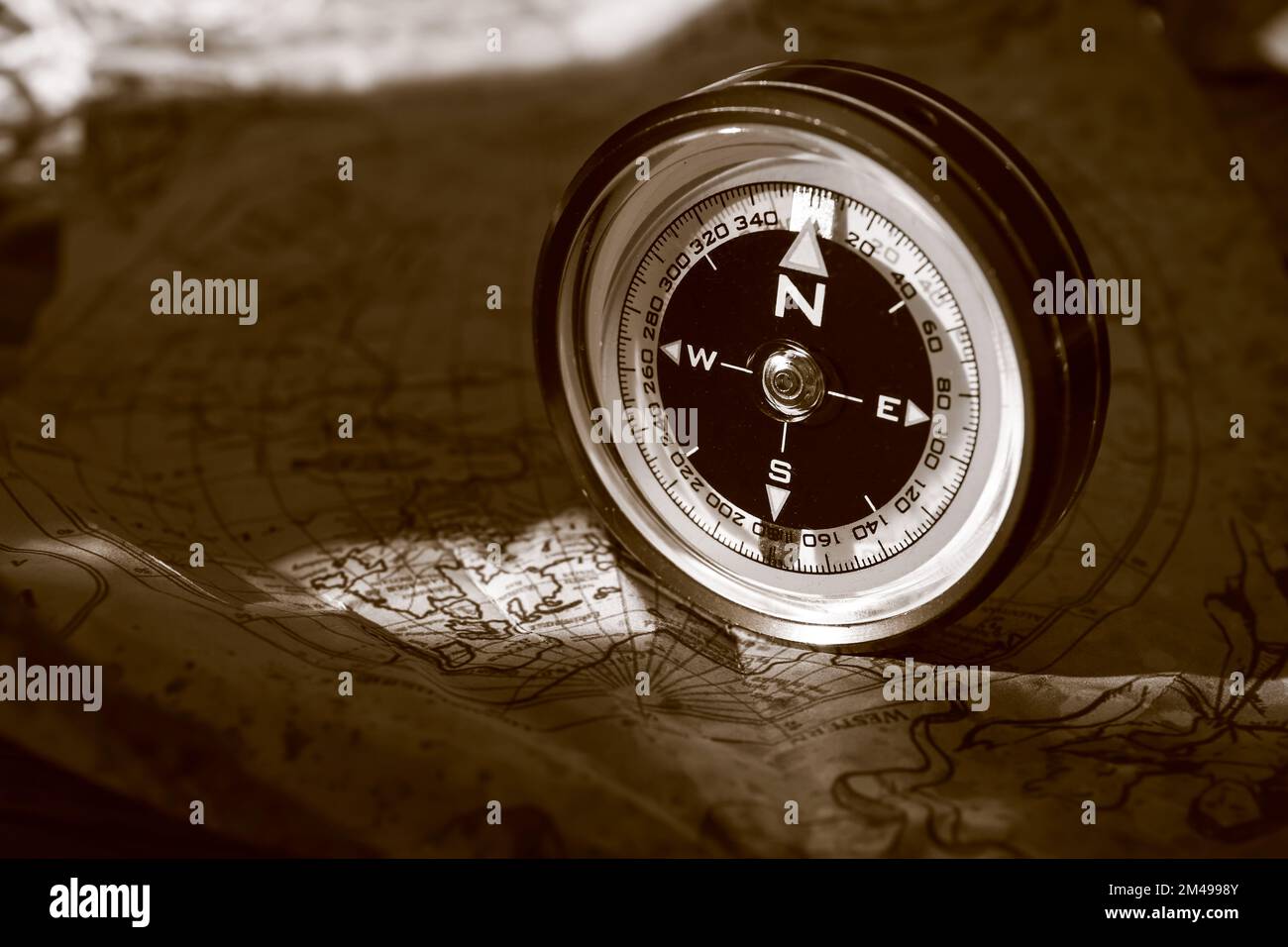 Compass on world map, closeup Stock Photo - Alamy