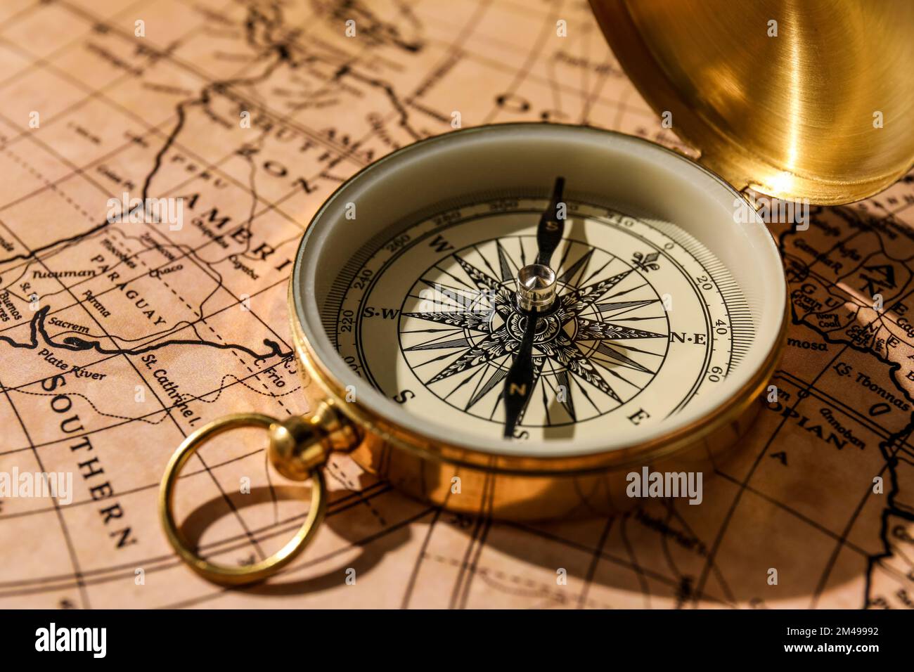 Vintage golden compass on world map, closeup Stock Photo - Alamy