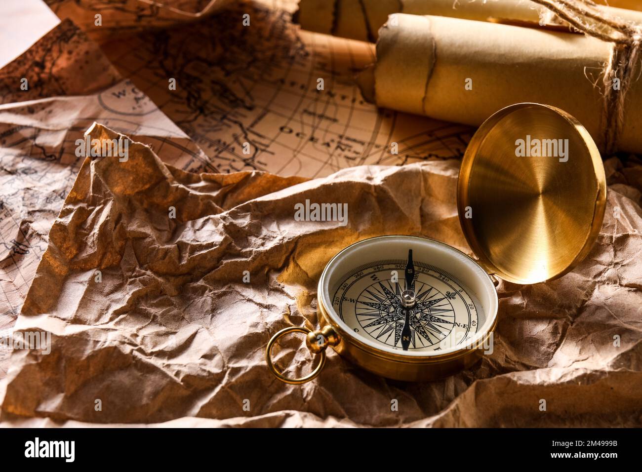 Vintage compass and crumpled paper on world map, closeup Stock Photo ...