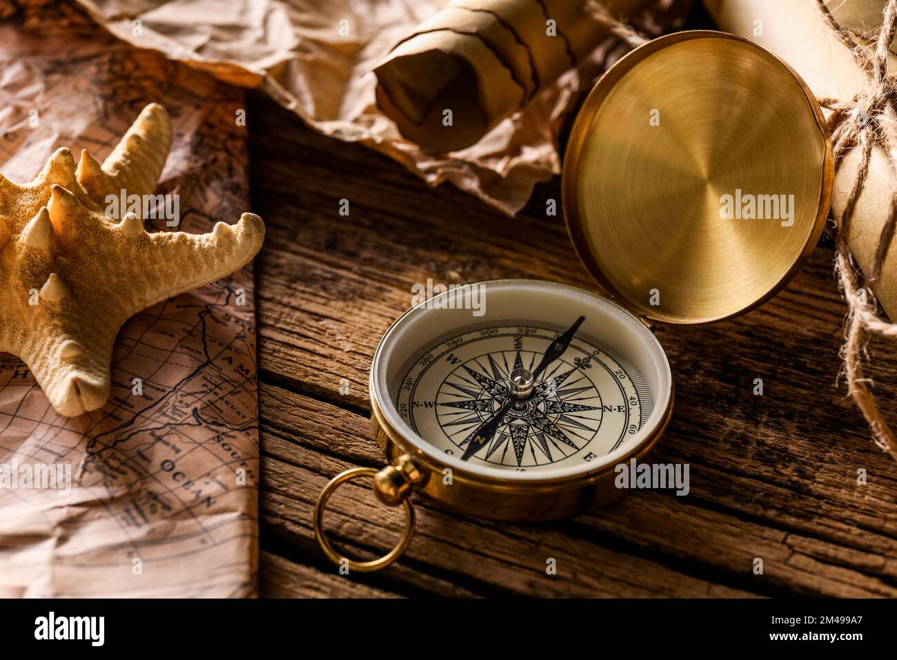 Vintage compass and starfish on wooden table, closeup Stock Photo - Alamy