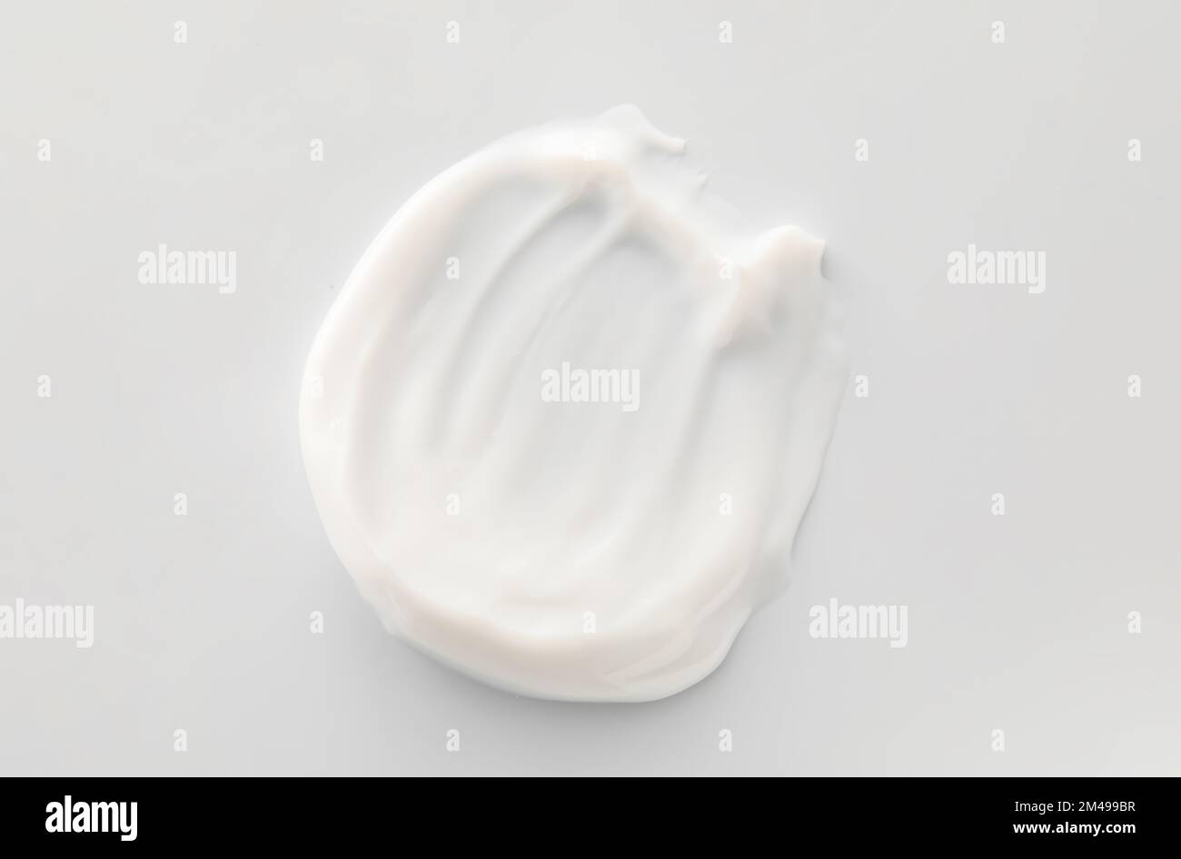 Smear of moisturising facial cream on grey background Stock Photo - Alamy