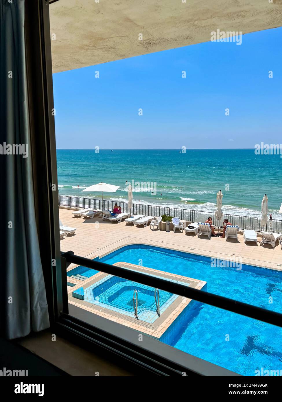 View from window at beach pool on sunny day Stock Photo - Alamy