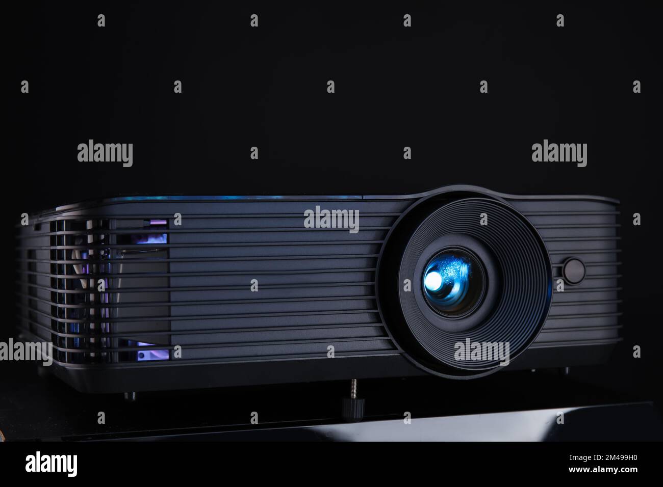 Modern video projector on black background Stock Photo - Alamy