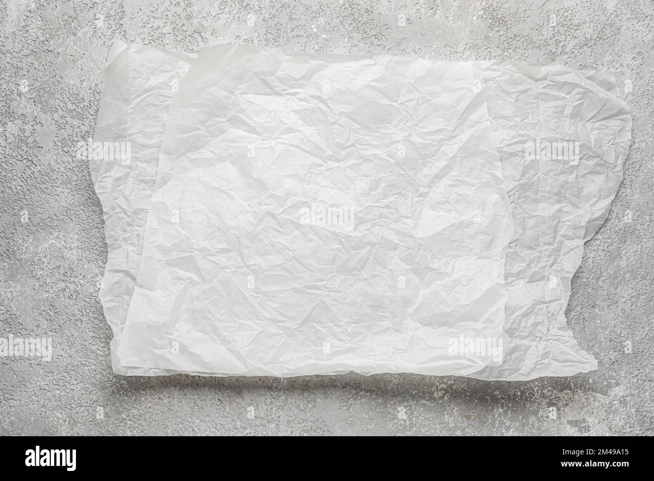 Baking paper on grunge background Stock Photo - Alamy