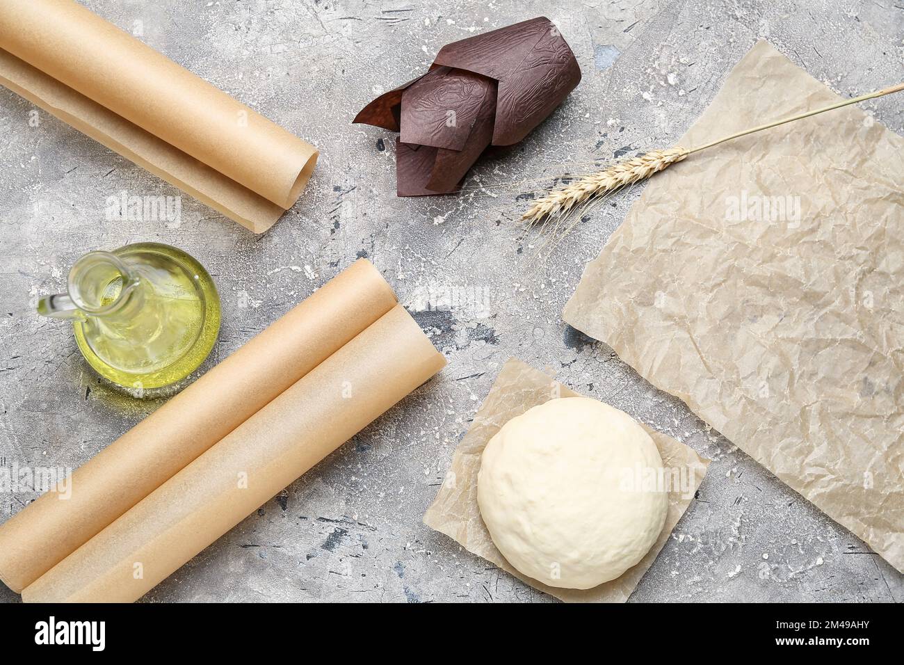Baking paper, dough and oil on grunge background Stock Photo - Alamy