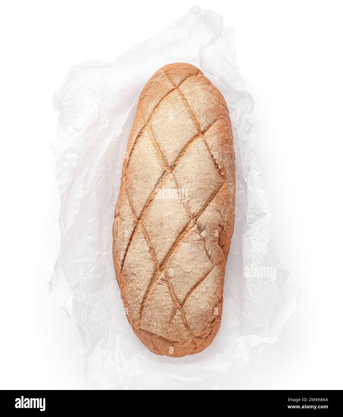 Baking paper with loaf of fresh bread on white background Stock Photo ...