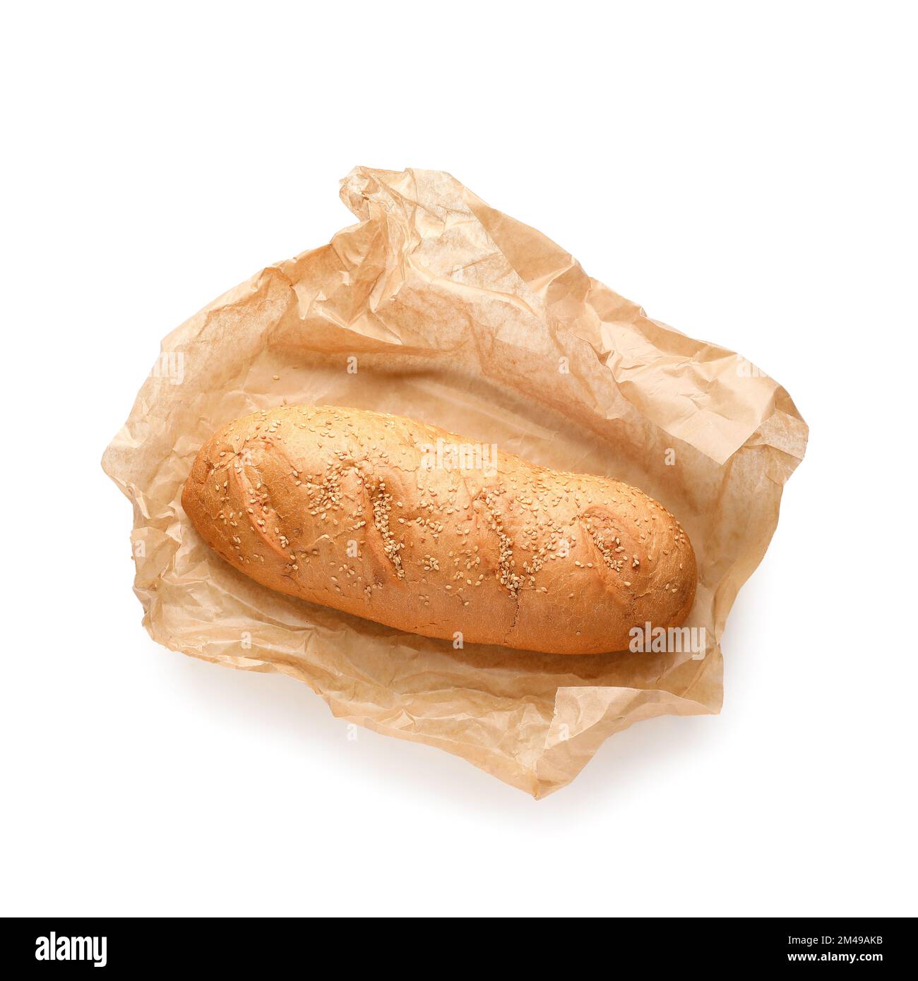 Baking paper with loaf of fresh bread on white background Stock Photo ...