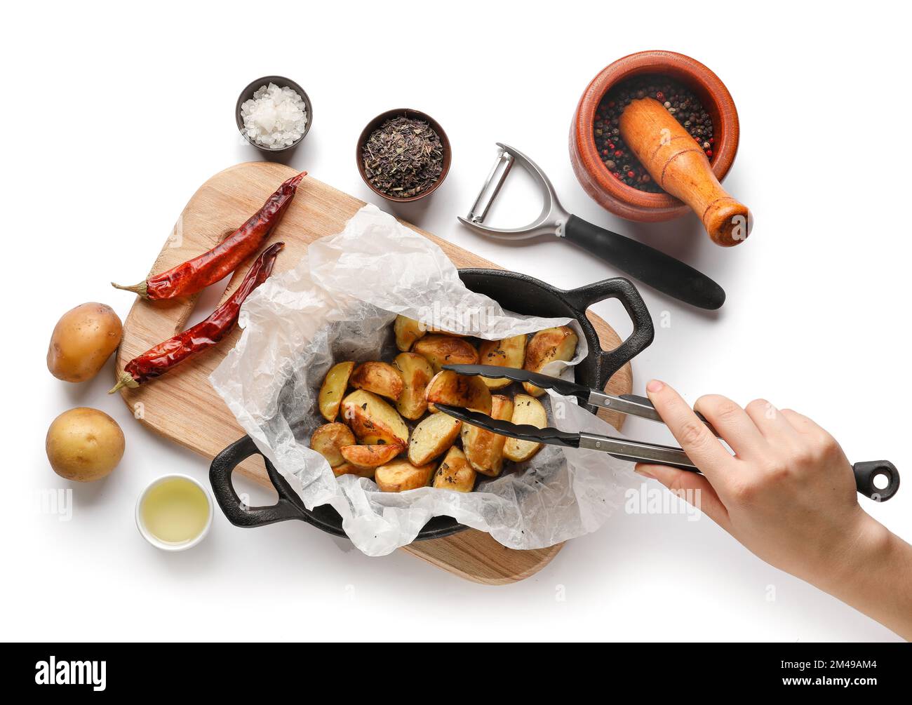 Female hand with tasty baked potato and ingredients on white background ...