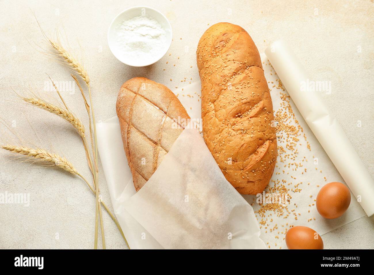 Baking paper with fresh bread on light background Stock Photo - Alamy