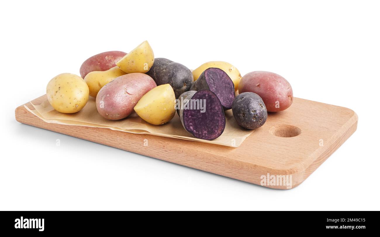 Wooden board with different types of raw potatoes isolated on white ...