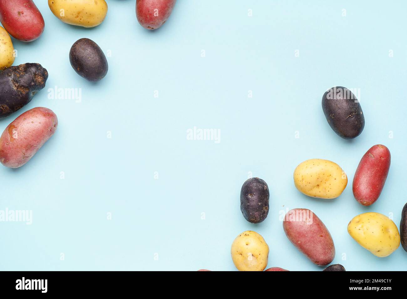 Different types of raw potatoes on blue background Stock Photo - Alamy