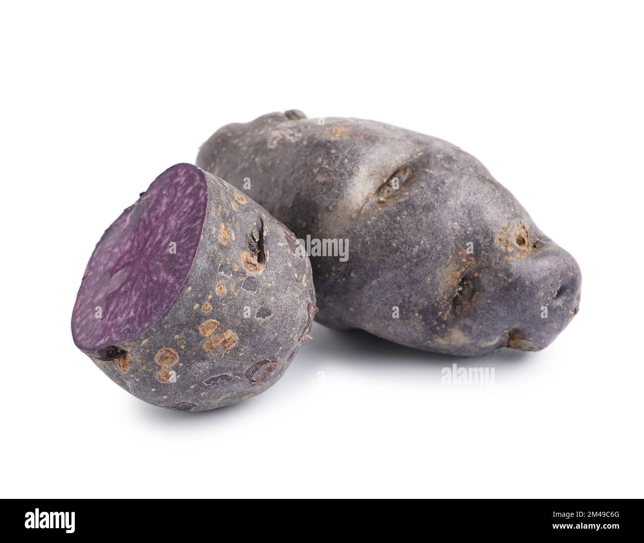 Cut and whole raw purple potatoes on white background Stock Photo - Alamy