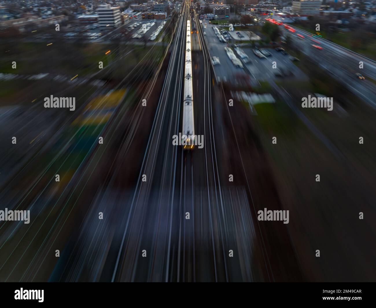 An aerial view of a high-speed train in motion on tracks in the city ...