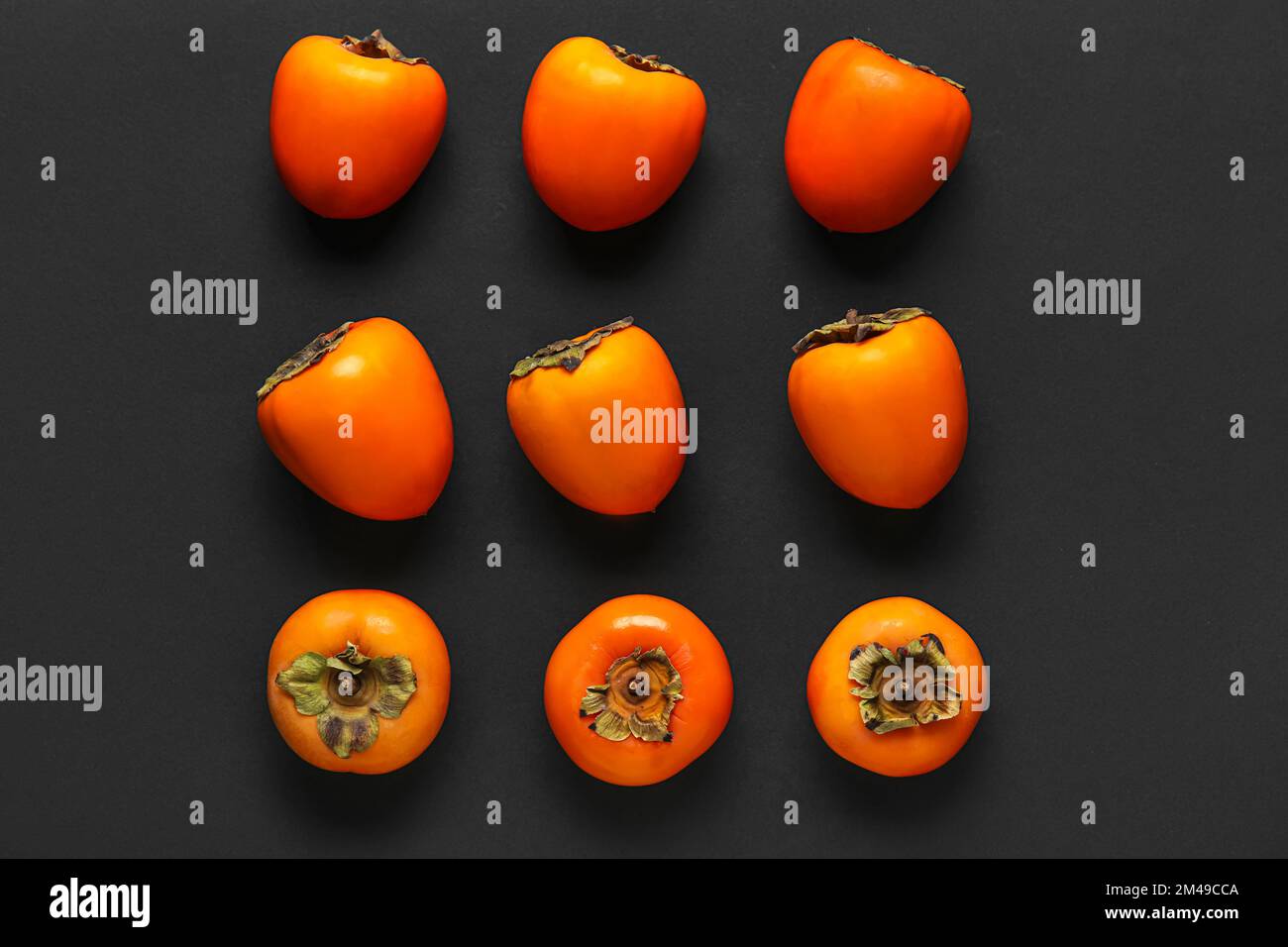 Fresh ripe persimmons on dark background Stock Photo - Alamy
