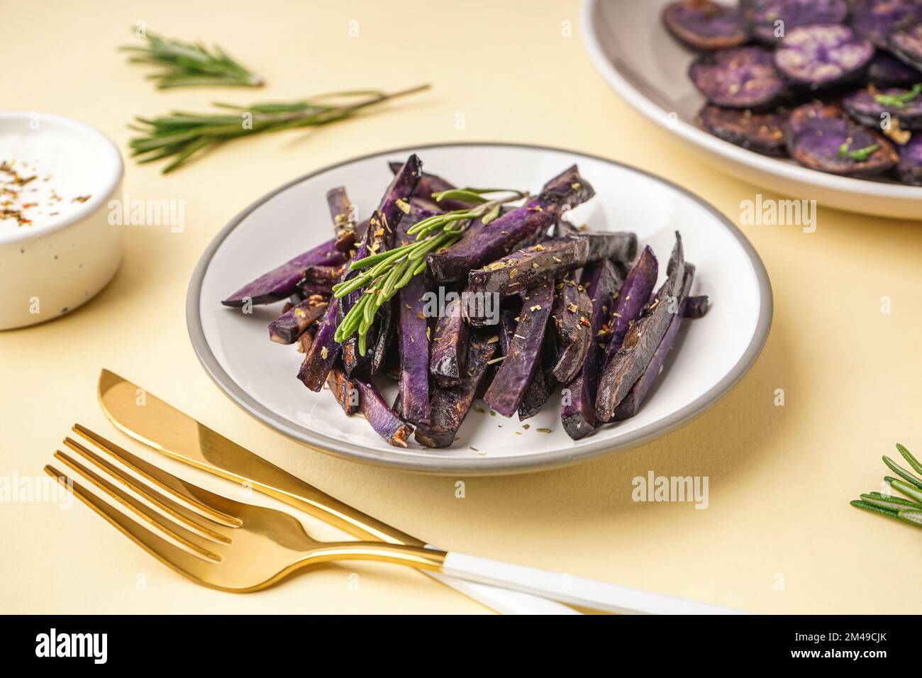 Plate with sticks of fried purple potatoes on color background Stock ...