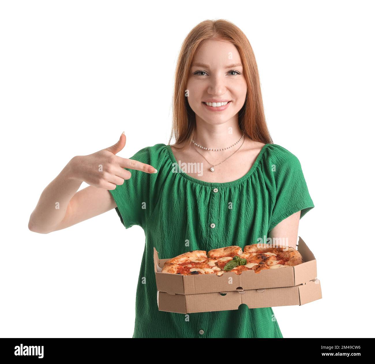 Young woman pointing at box of tasty pizza on white background Stock ...