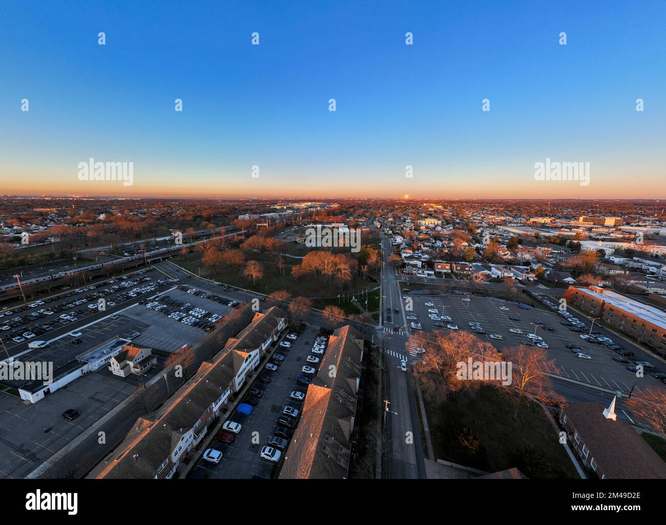 An aerial view of a beautiful sunset sky over a suburban neighborhood ...