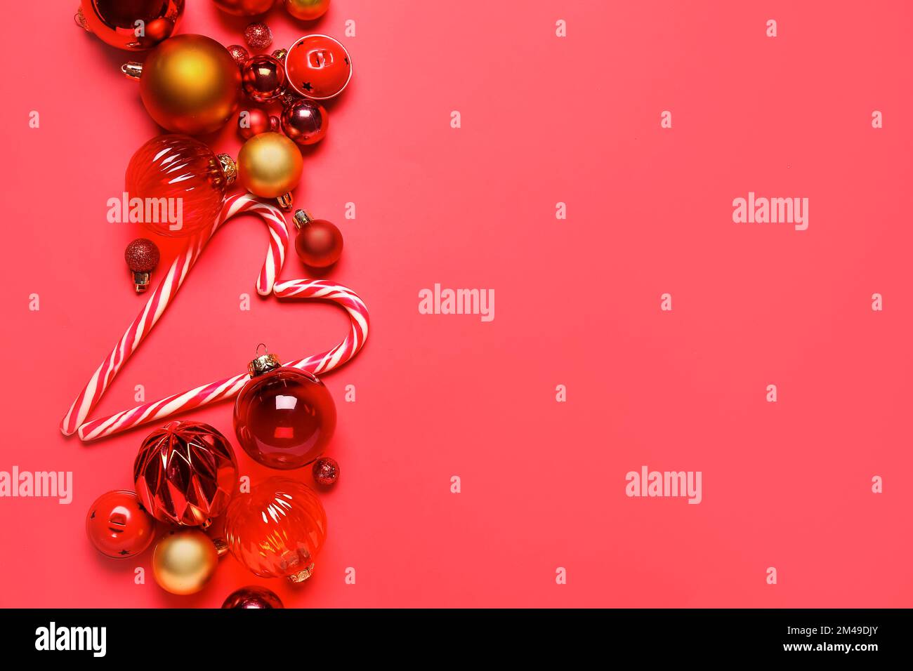 Christmas balls with candy canes on red background Stock Photo - Alamy
