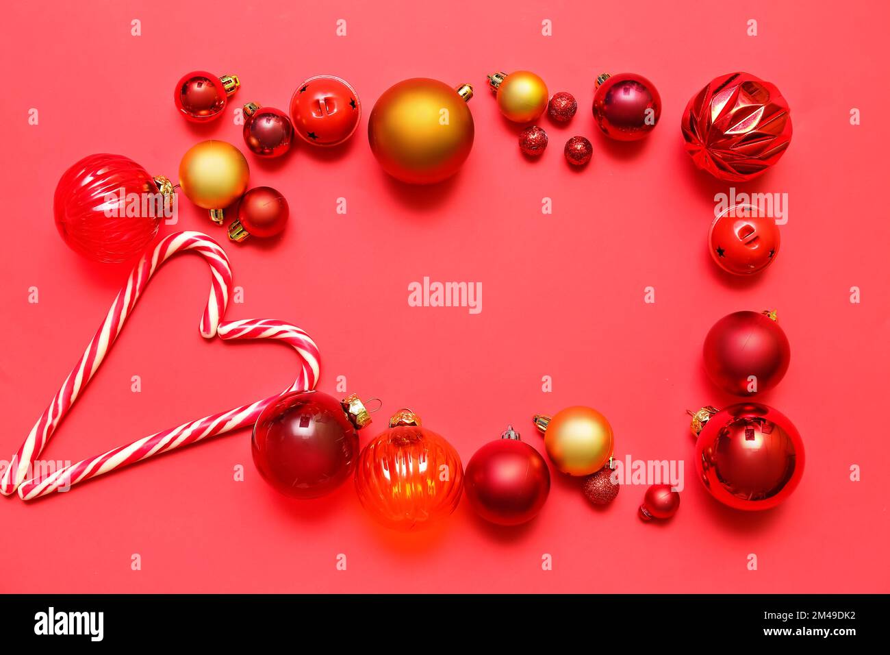 Frame made of Christmas balls and candy canes on red background Stock ...