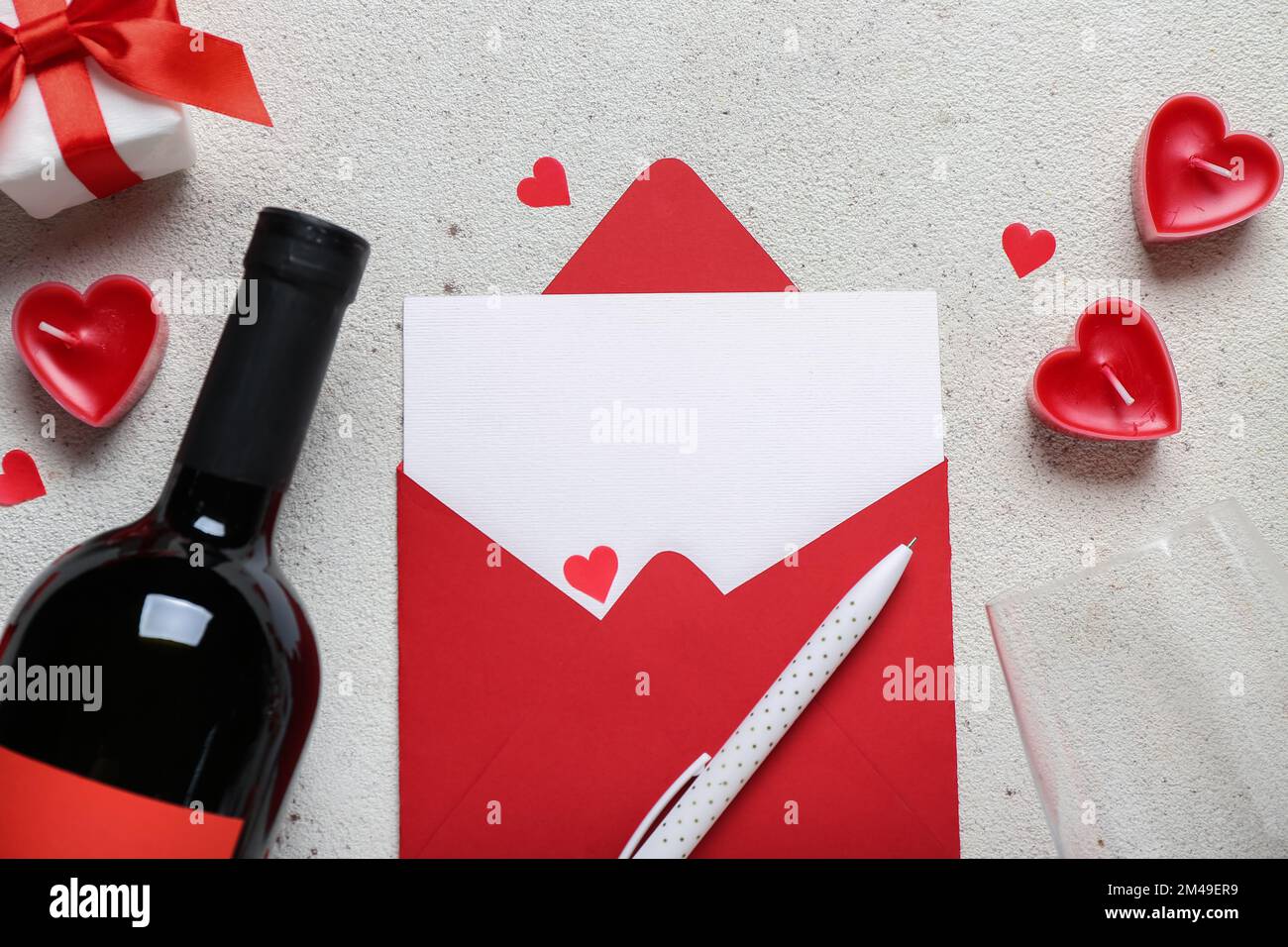 Blank letter with bottle of wine, gift and hearts on white background ...