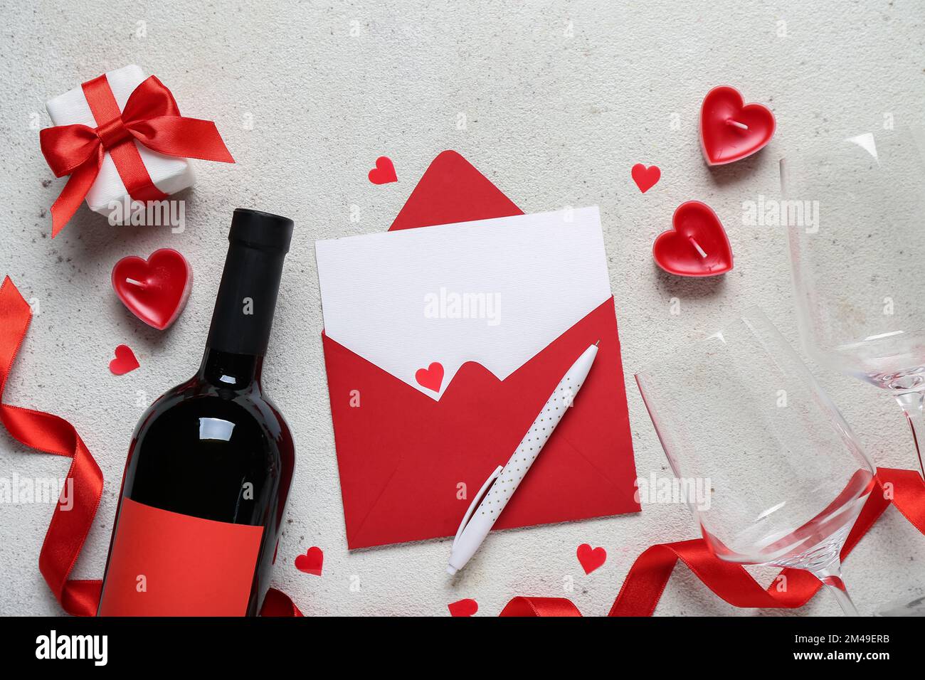 Blank letter with bottle of wine, gift and hearts on white background ...