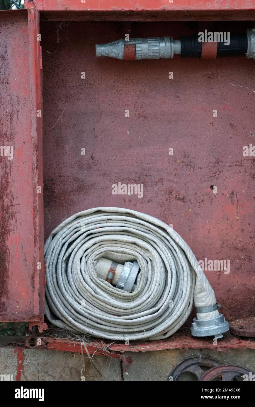 Fire brigade loop rolled up in a box Stock Photo - Alamy