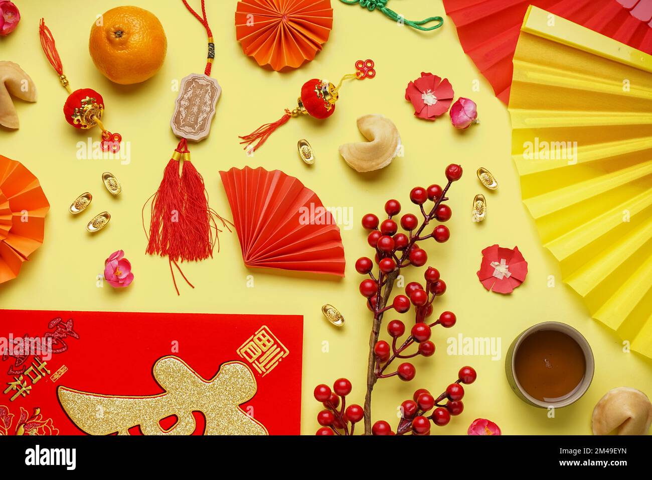 Fortune cookies, cup of tea, mandarin and Chinese symbols on yellow ...
