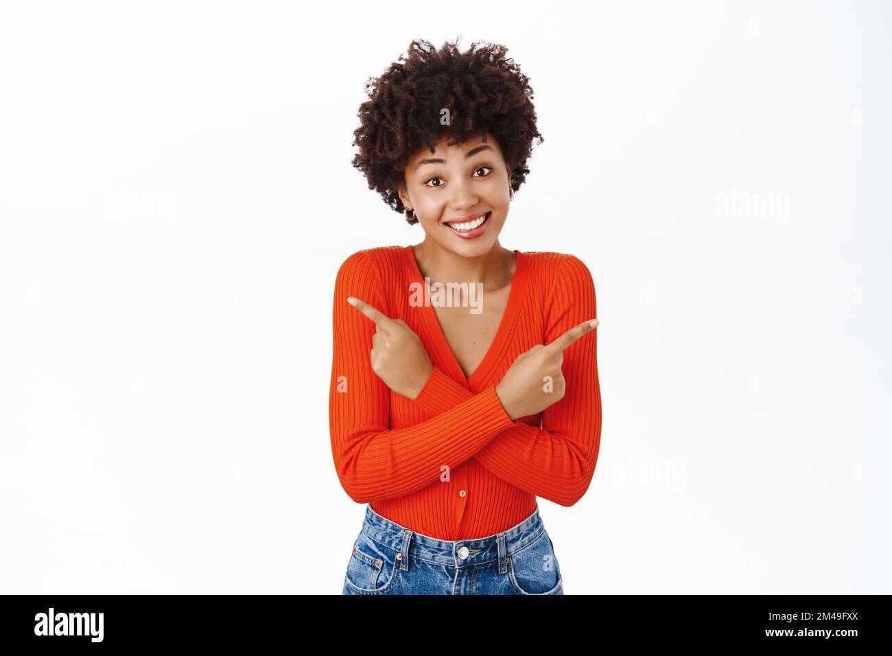 Smiling beautiful girl points sideways, shows left and right promo ...