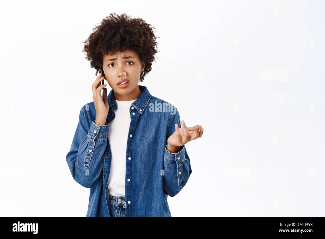 Woman talks on the phone with confused face. Girl answer call on ...