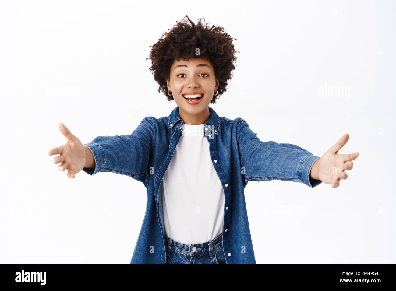 Woman spreads her arms for hug, cuddle, stands with open hands and ...