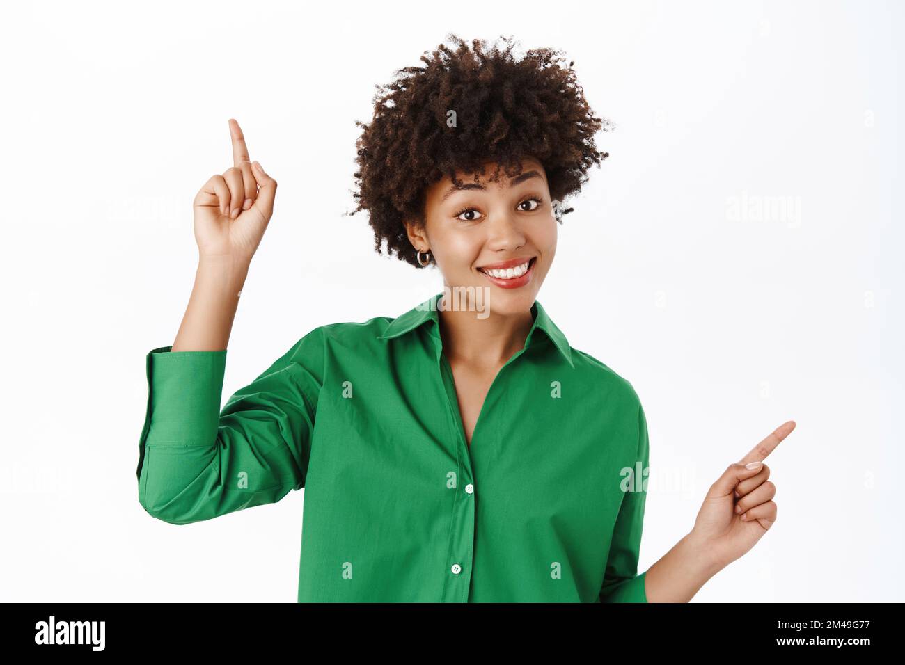 Portrait of beautiful african american woman pointing fingers sideways ...