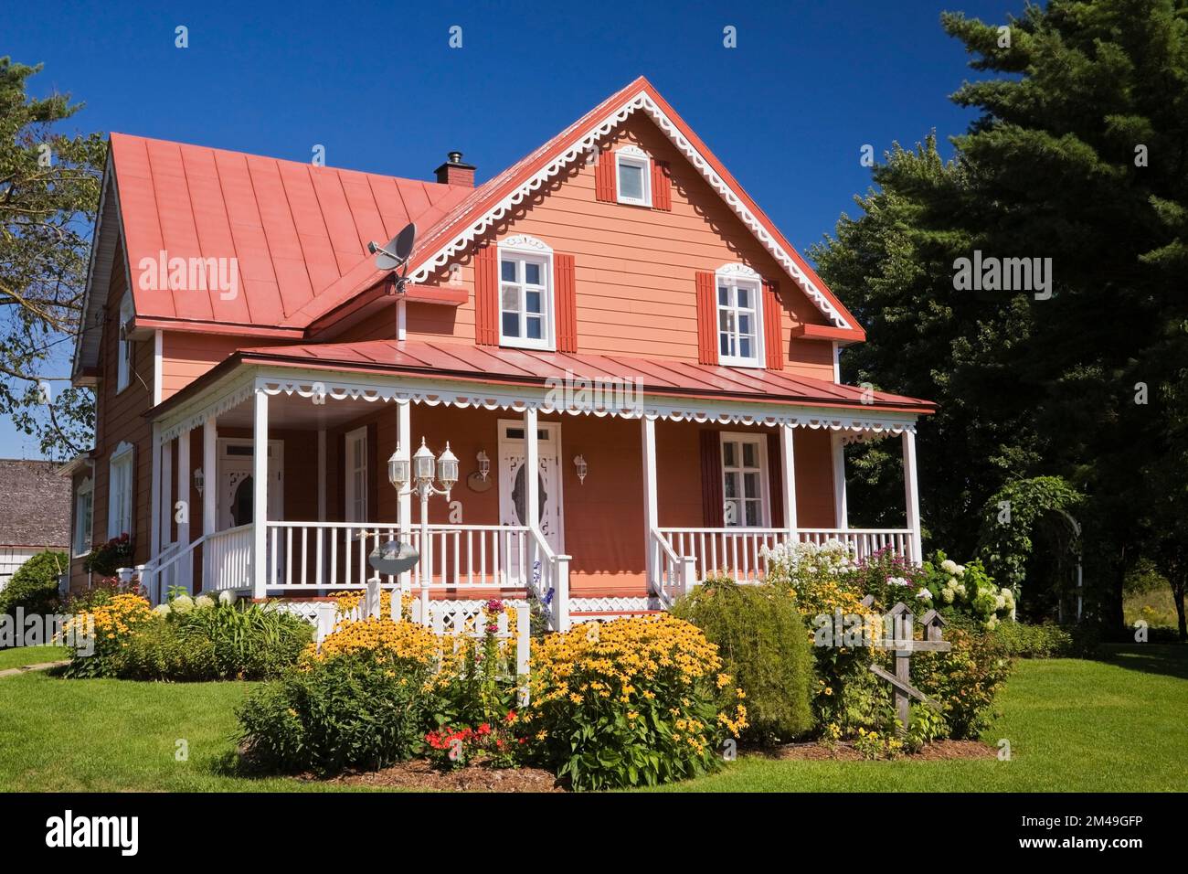 Old 1800s salmon and white trim cottage style home with landscaped ...